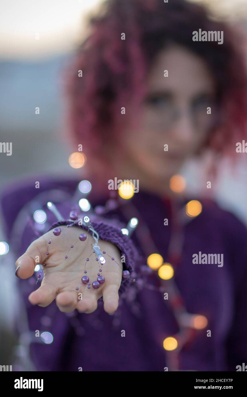 Pretty young girl with lights in her hand Stock Photo - Alamy