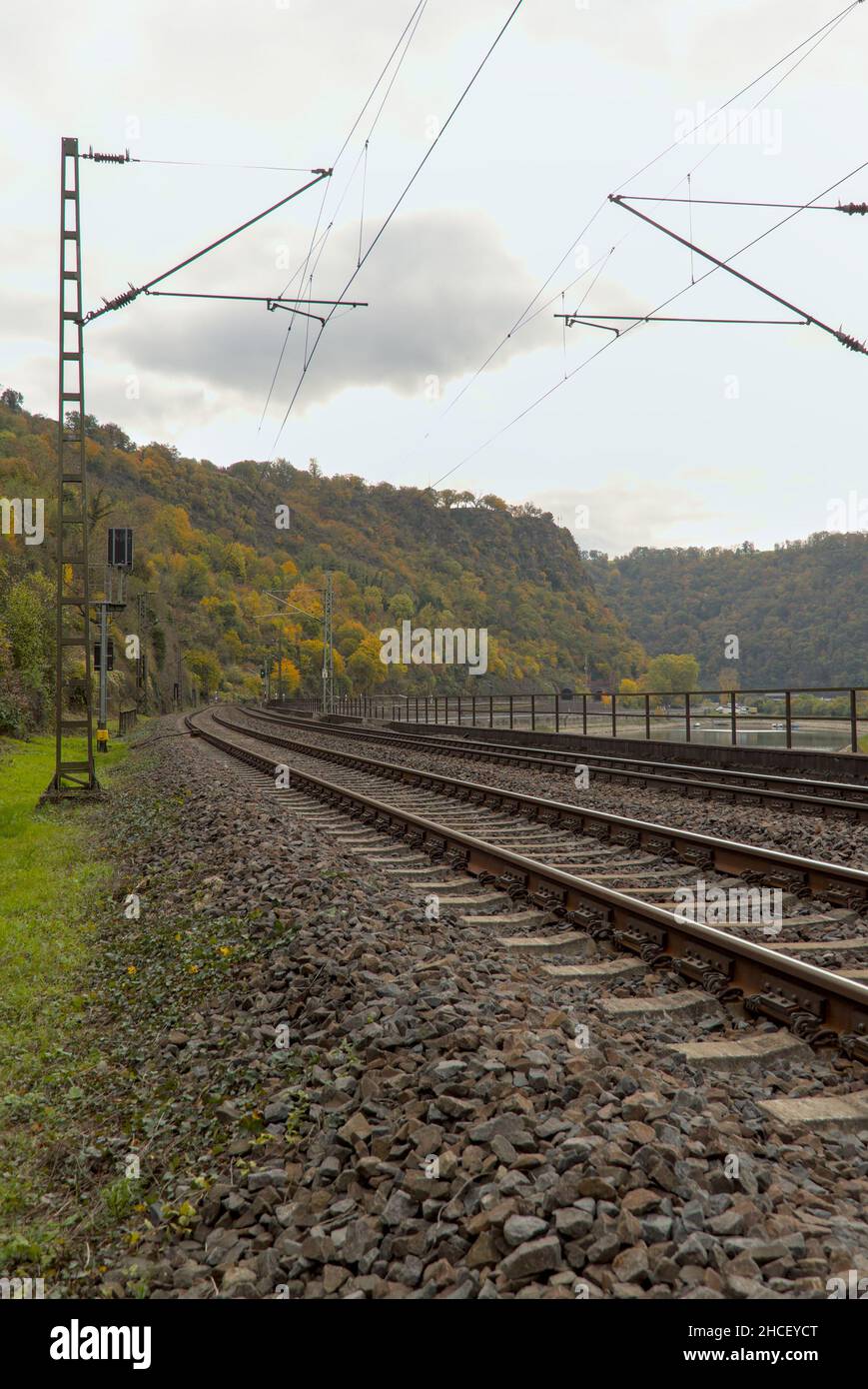 Vertical shot of railroad tracks and power lines heading to the left ...