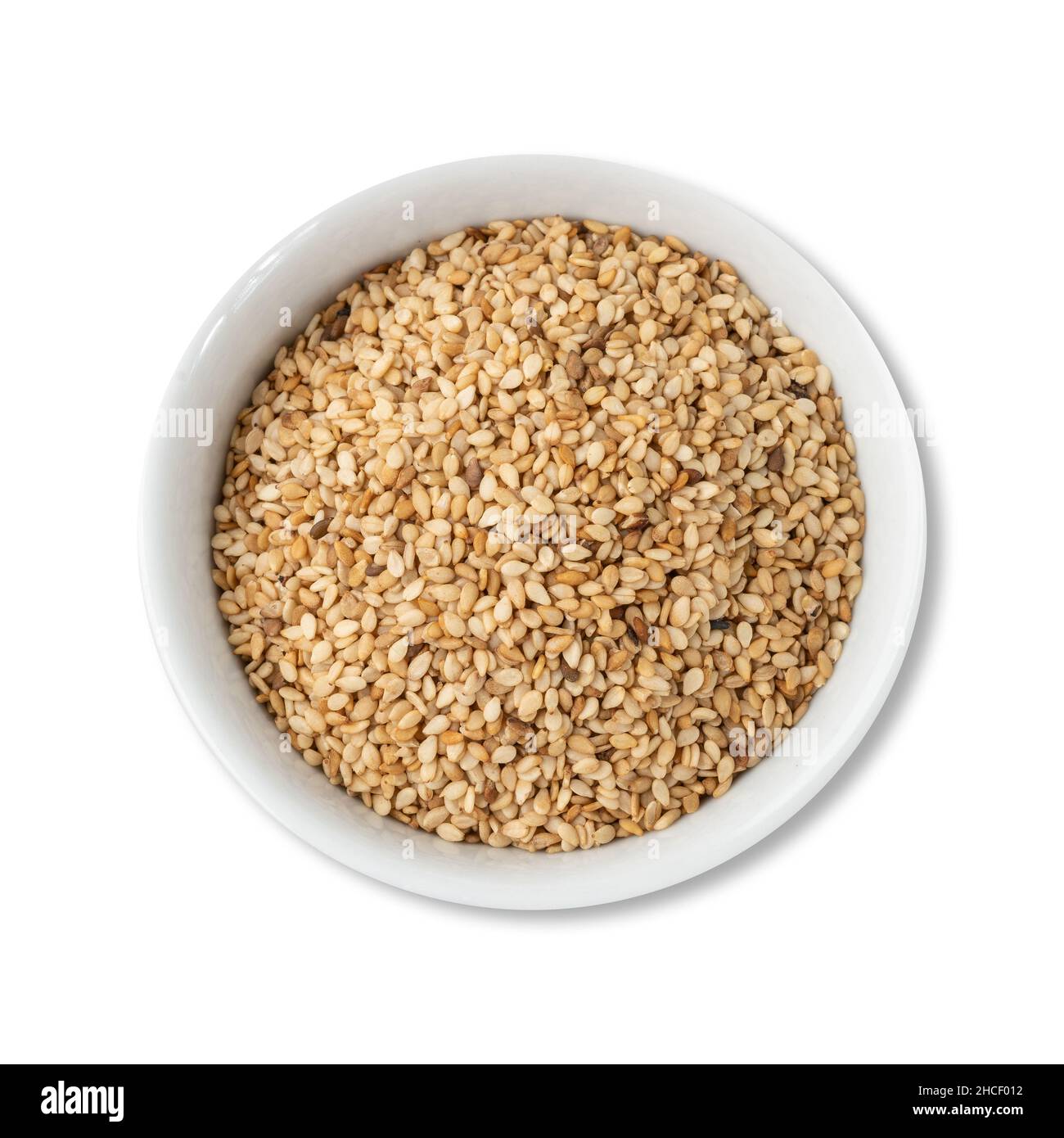 Sesame seeds in a bowl isolated over white background Stock Photo - Alamy