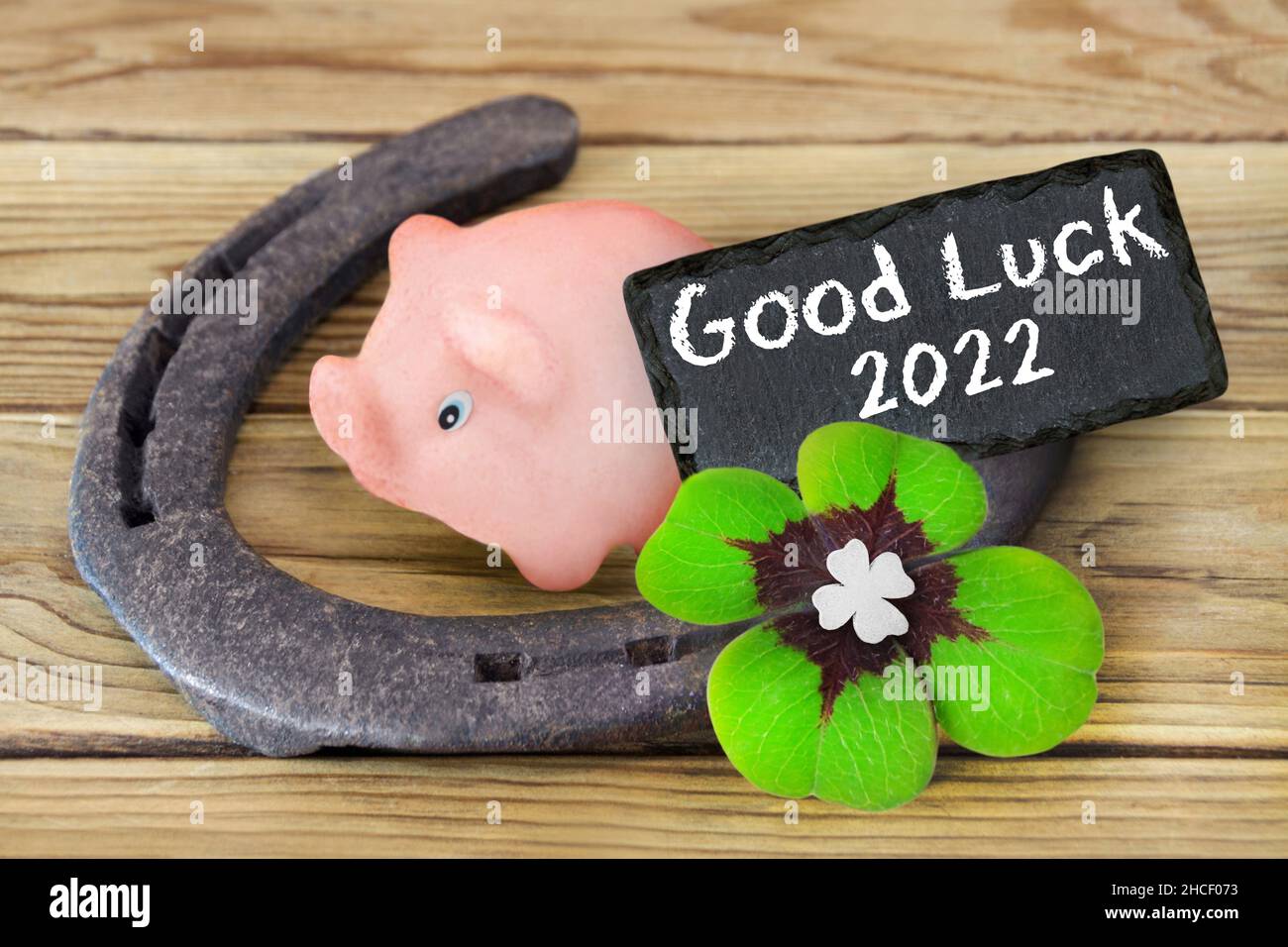Lucky symbols marzipan piggy and clover with Good Luck 2022 on wooden ...