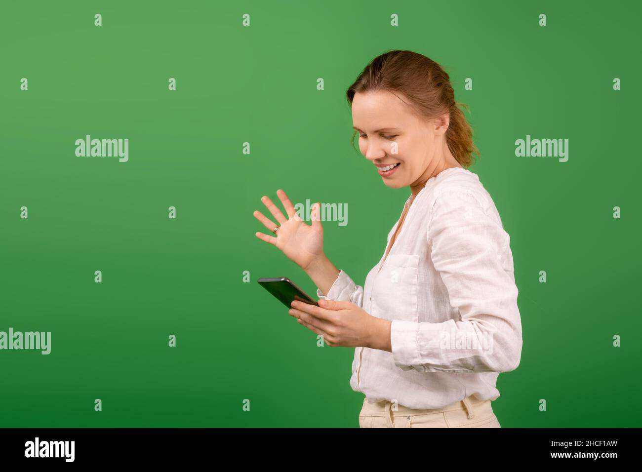 Joyful, contented woman of middle age 40 years old in a white shirt ...