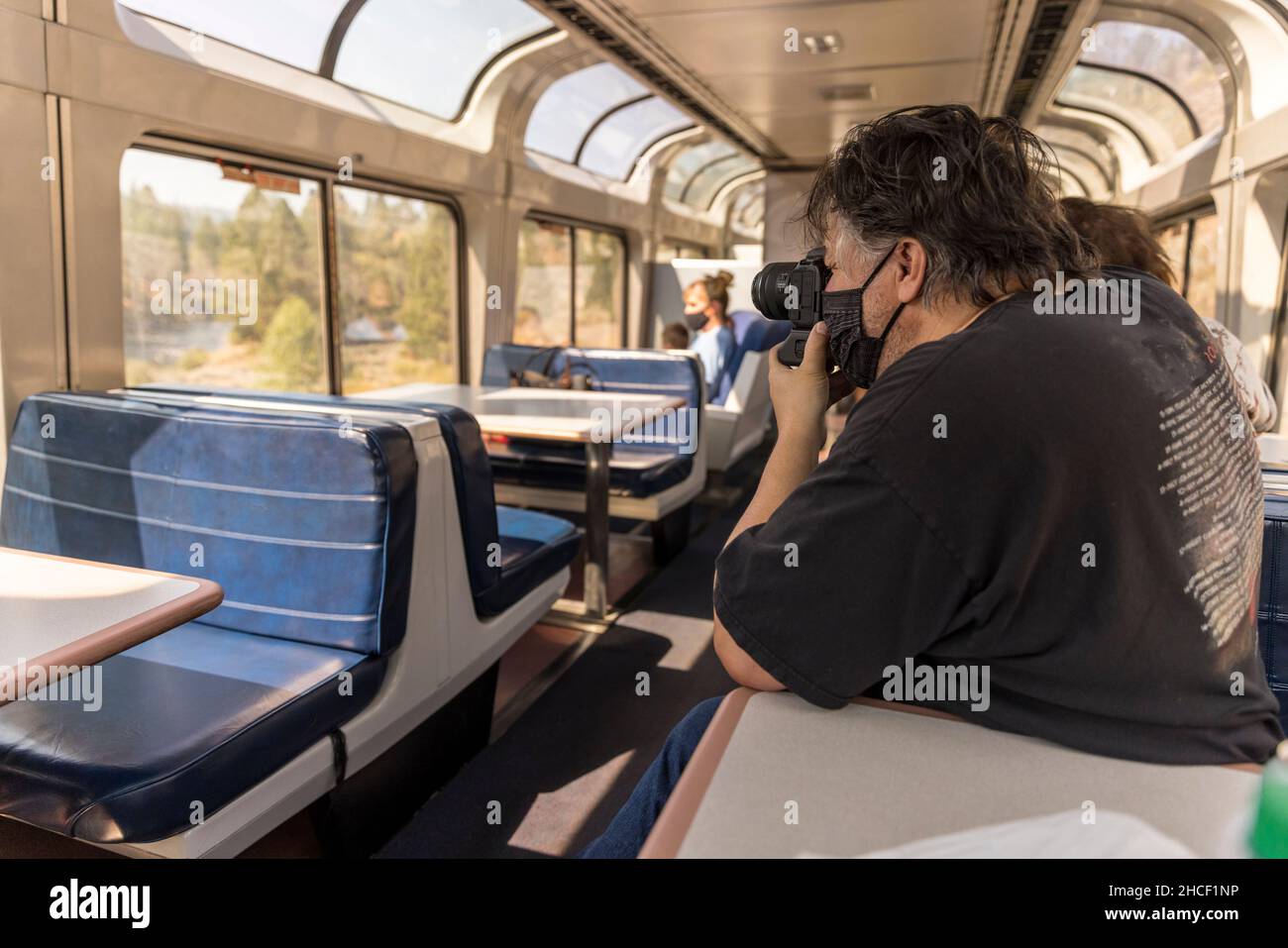 Man inside the observation car uses a tiny camera to take photos out of ...