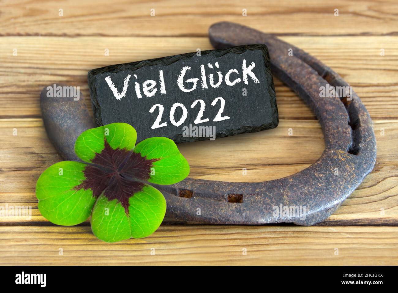 Lucky symbols horse shoe and clover with German Good Luck 2022 on ...