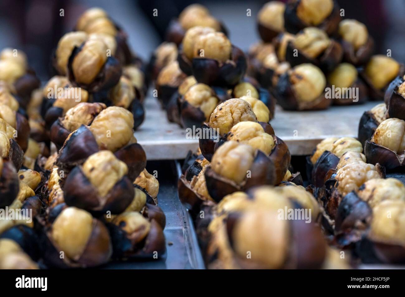 Fried chestnuts on street. Traditional street food in winter fire ...