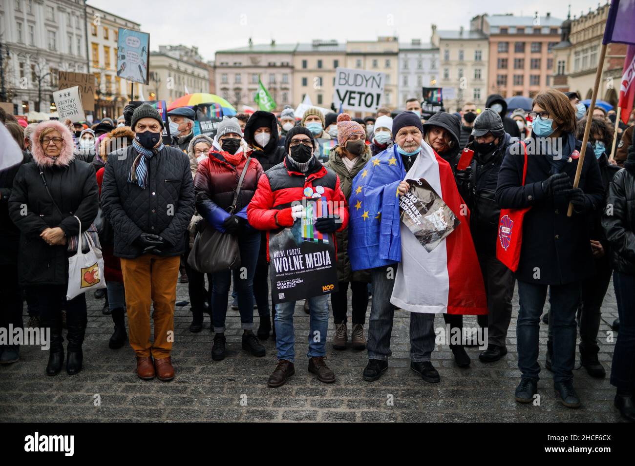 Protesters wearing protective face masks and holding banners advocating ...