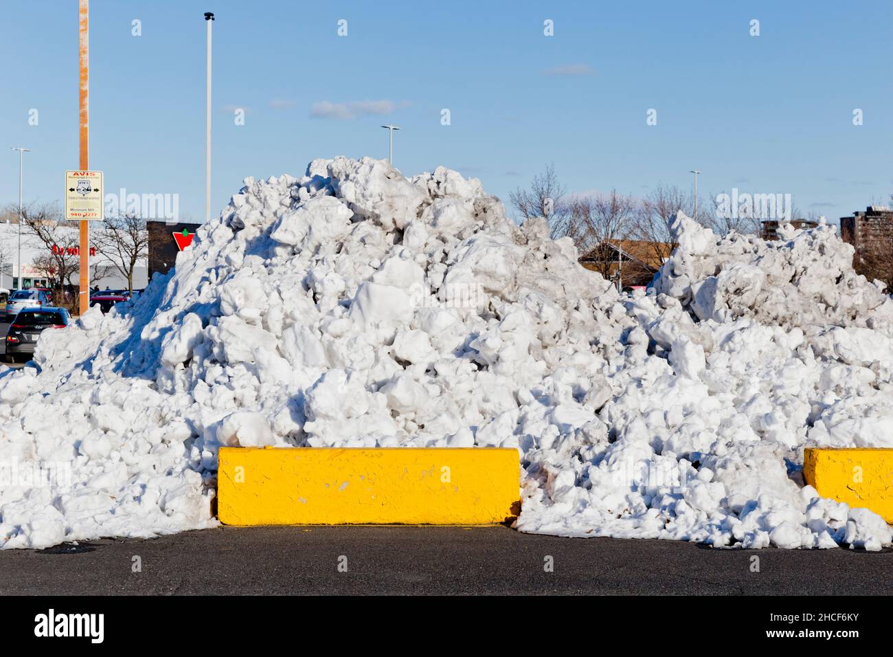 A pile of cleared snow in a mall car park in Longueuil, Quebec, Canada ...