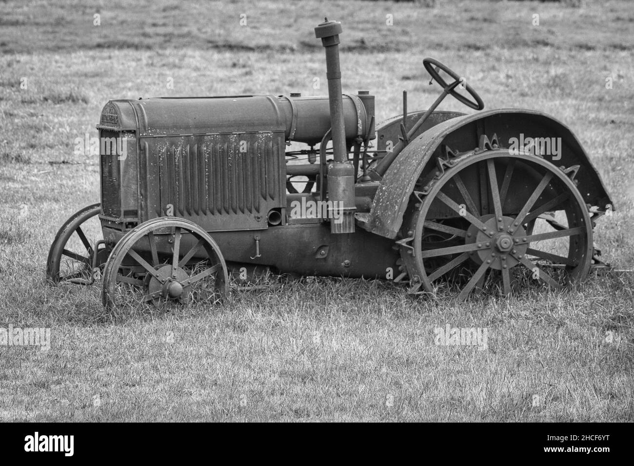 Grayscale of an old tractor in the field Stock Photo - Alamy
