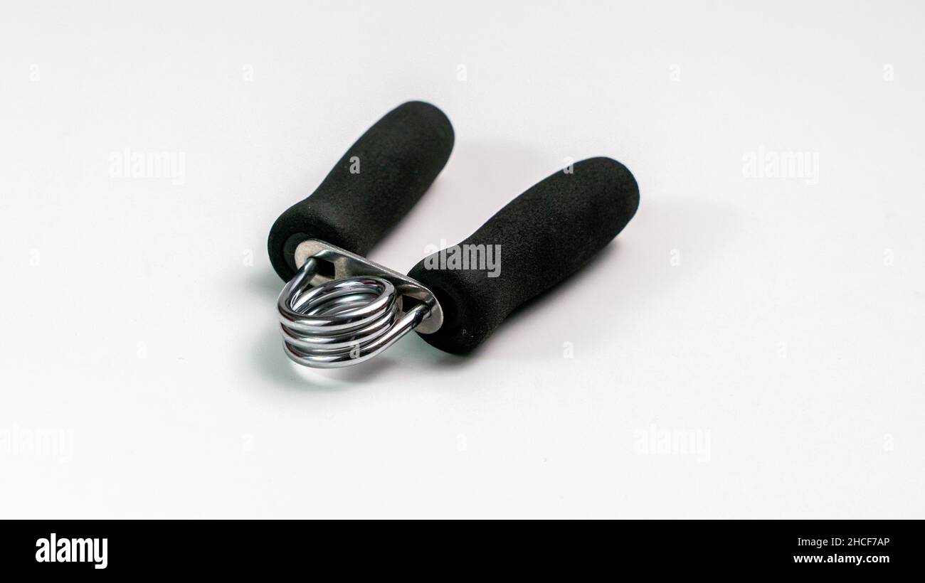 Closeup shot of a hand exercise clamp isolatedon a white background ...