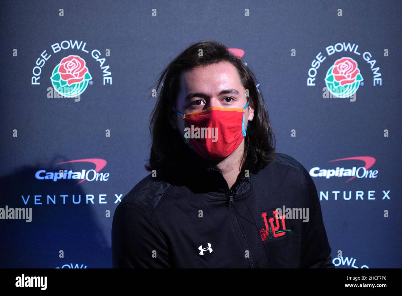 Utah Utes quarterback Cameron Rising wears a face mask at a press ...