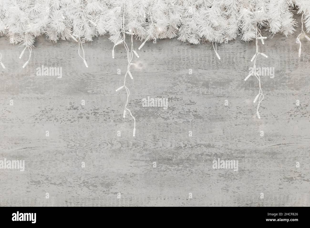 Wood texture with white christmas snow fir tree decor and garlands ...