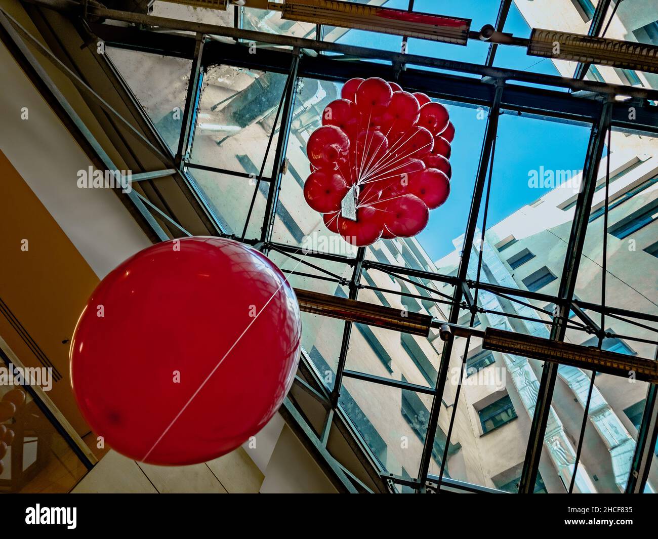 Scenic view of red balloons in the air inside a building Stock Photo ...
