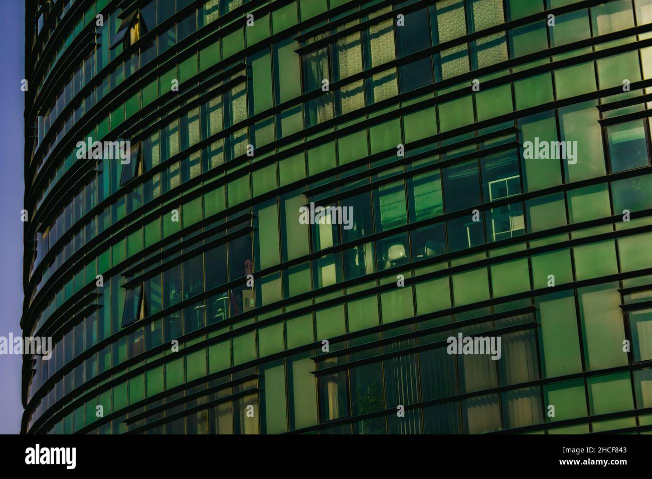Exterior view of a building with green glass windows Stock Photo - Alamy