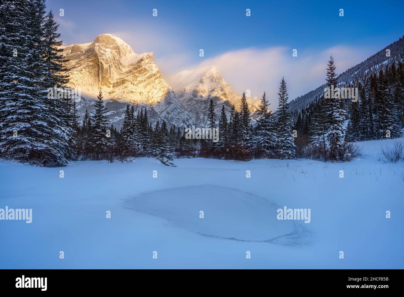 Fast Moving Clouds on Top of Mount Kidd during Sunrise Stock Photo - Alamy