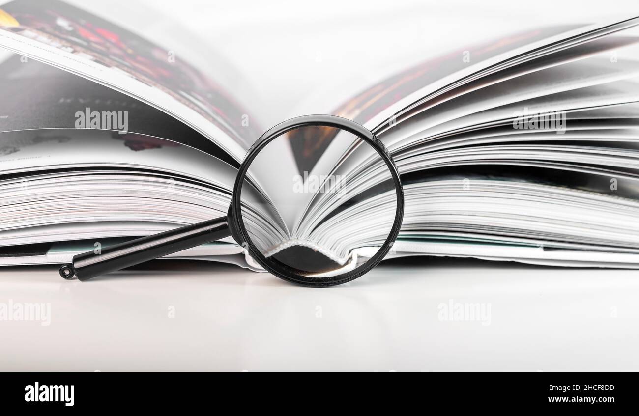 Magnifying glass over open paper art book with pages. Concept of ...