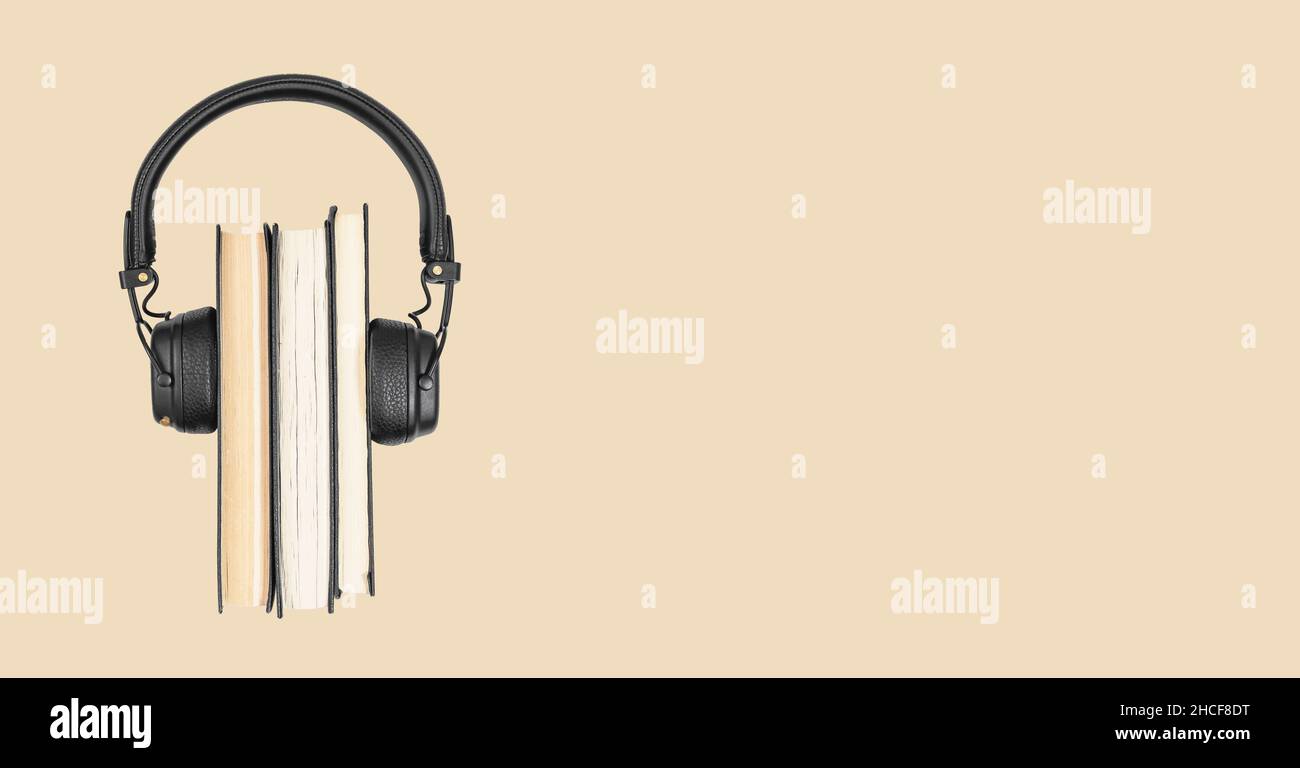 Audio books concept. Classic paper literature stack with headphones ...