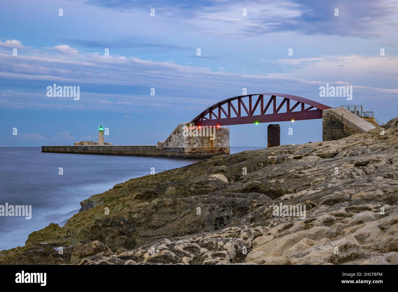 Beautiful landscape of breakwater during sunset Stock Photo - Alamy