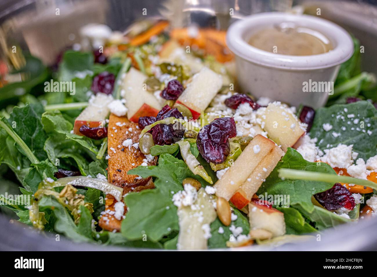 Closeup of a delicious fresh veggie salad in a metal container with a ...