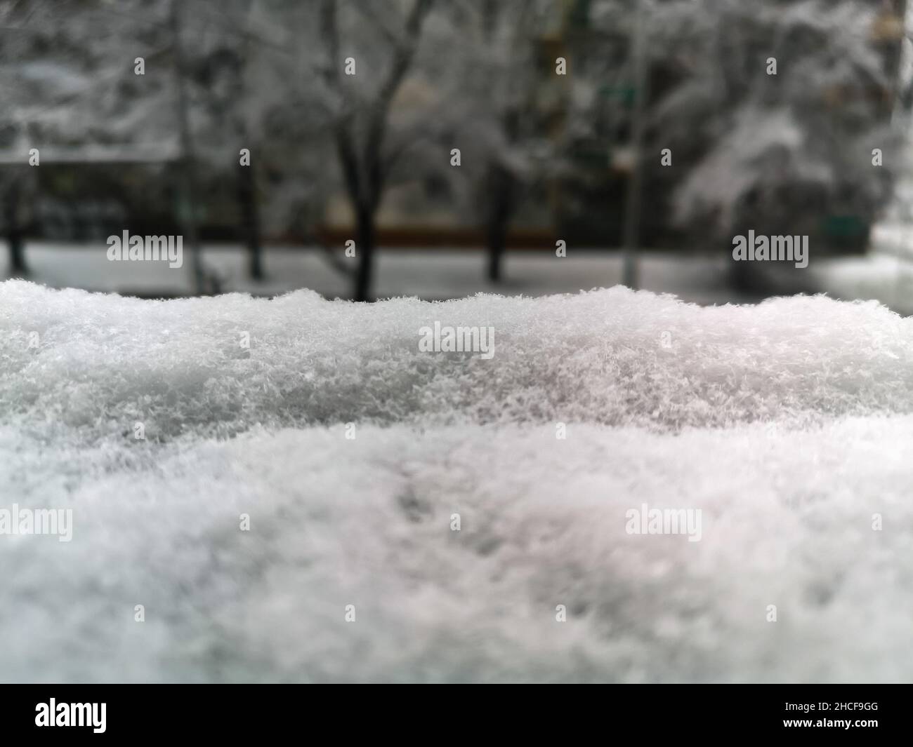 Fresh fallen white snow laying on windowsill behind window Stock Photo ...