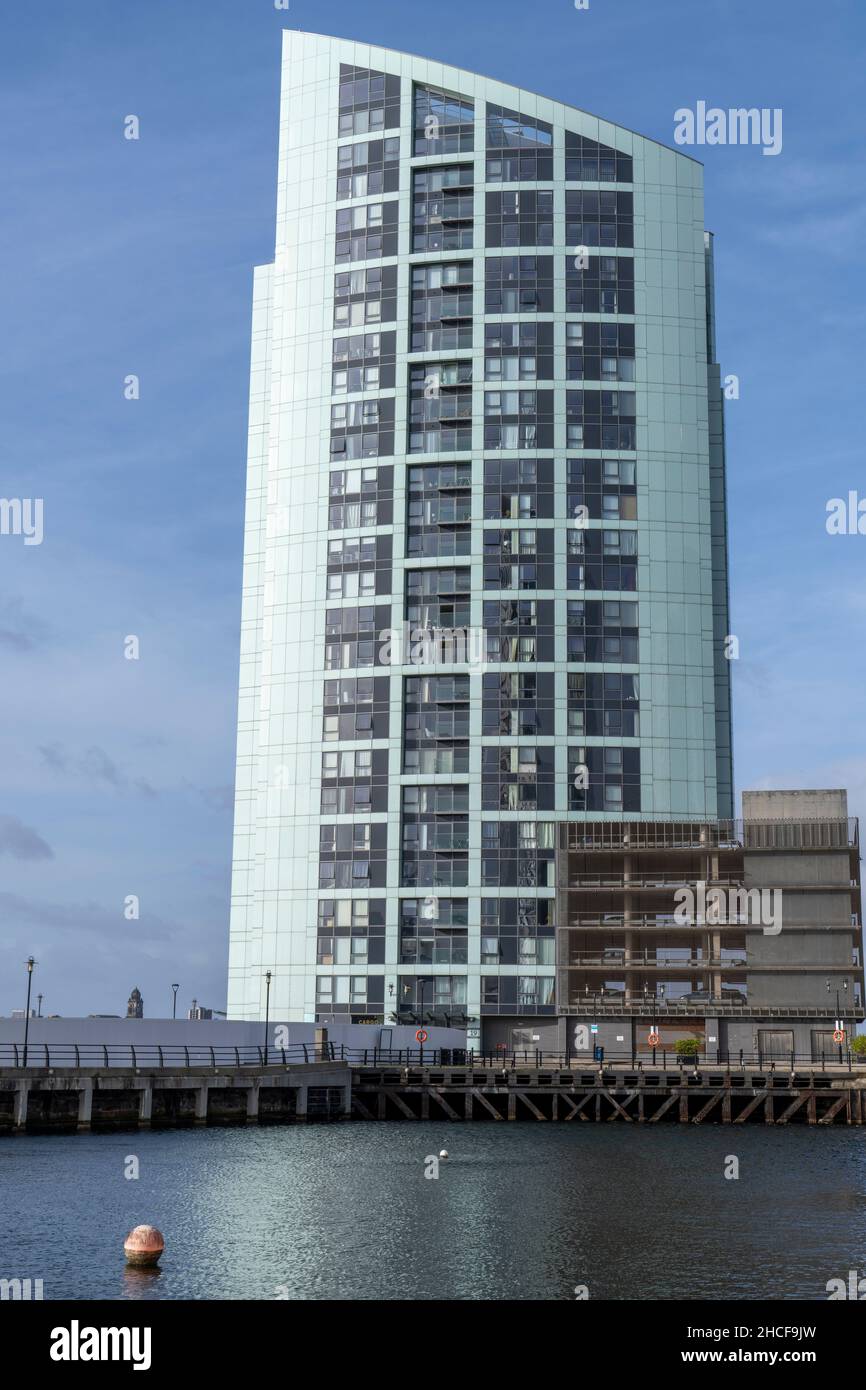 Vertical shot of the office blocks with panoramic windows by a river in ...