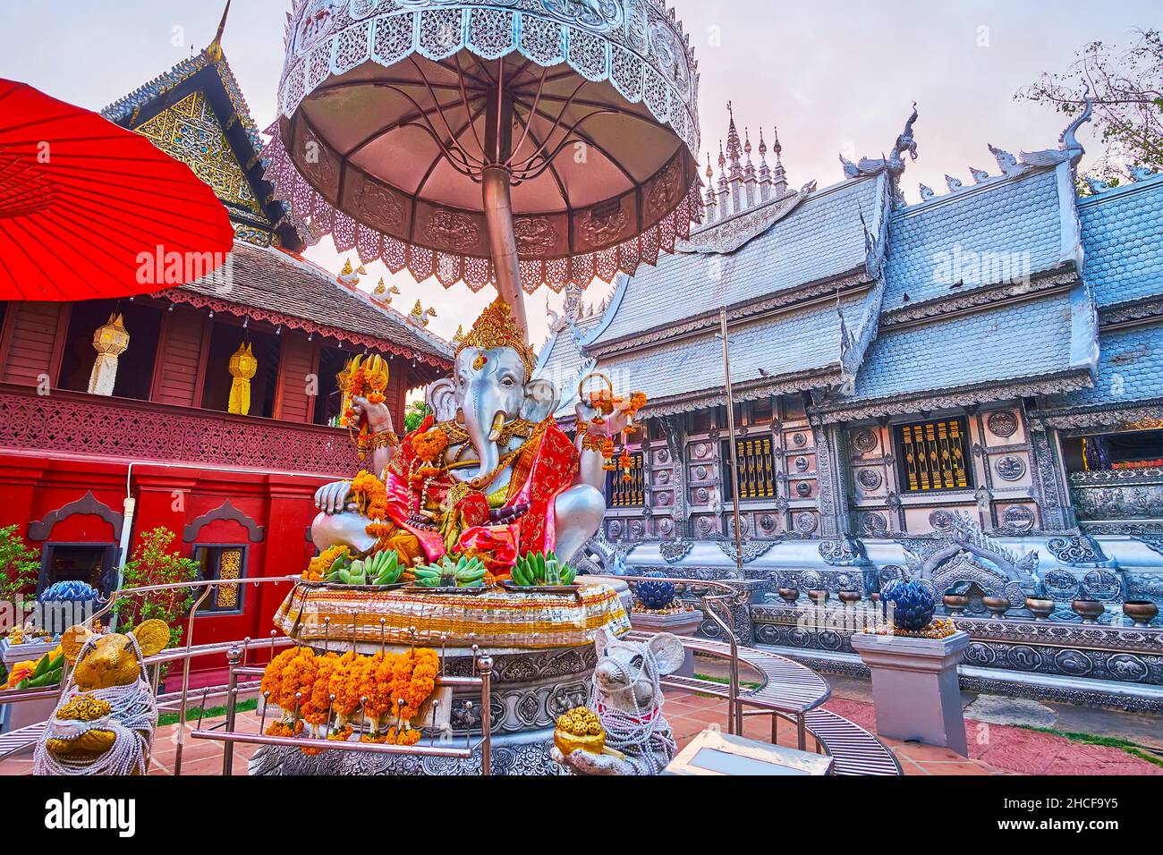 The altar of Ganesha shrine with chatra umbrella and floral garlands ...
