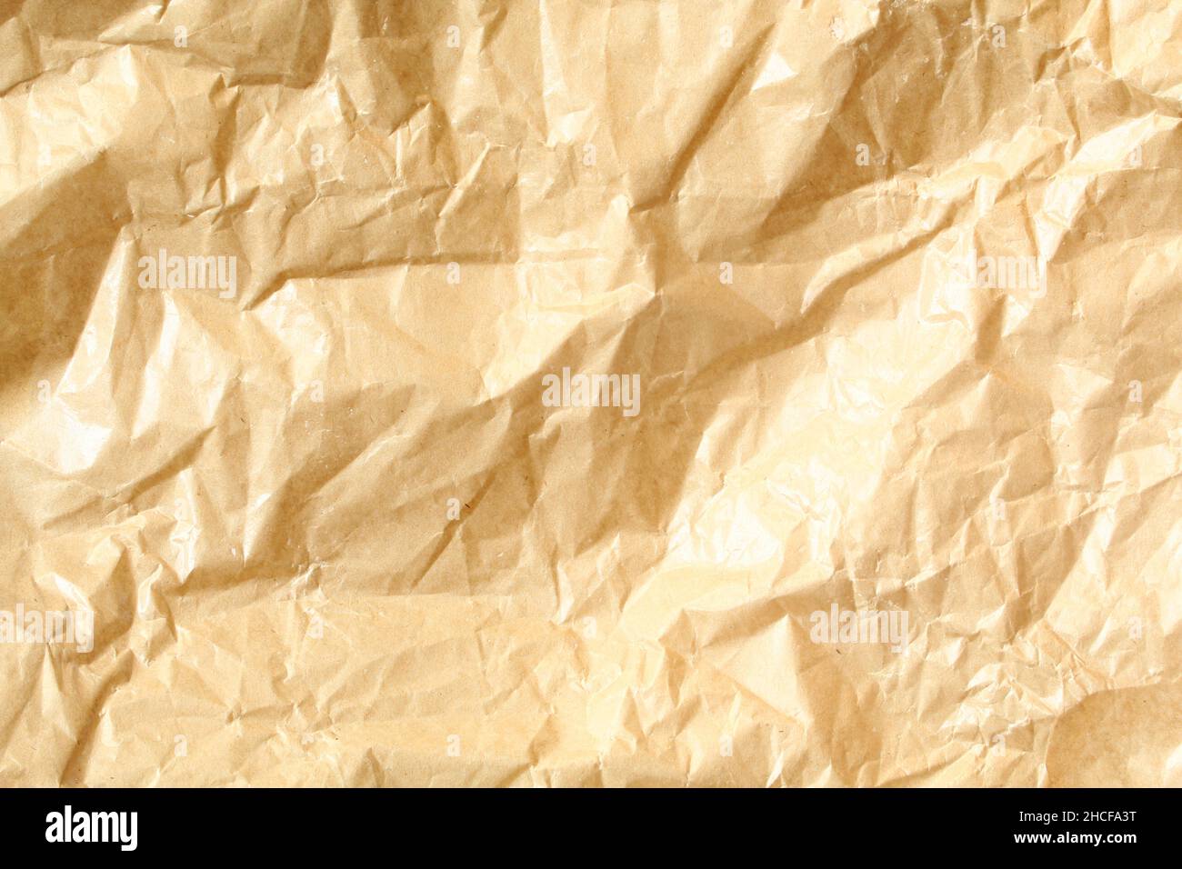 Wrinkled golden color paper background texture. Full frame pattern ...