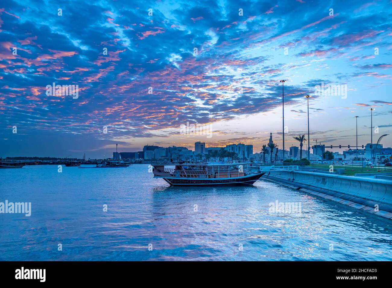 Sunrise view of Corniche Beach with Dhow boat Stock Photo - Alamy
