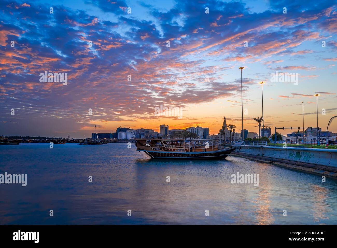 Sunrise view of Corniche Beach with Dhow boat Stock Photo - Alamy