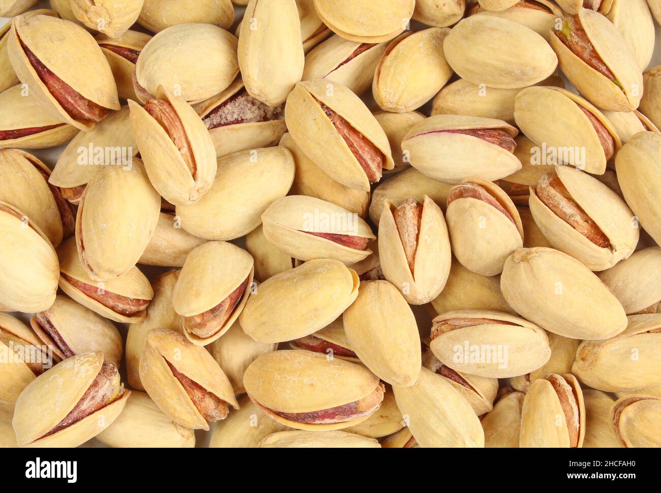 Background full of salted pistachios. Shelled fruit Stock Photo - Alamy