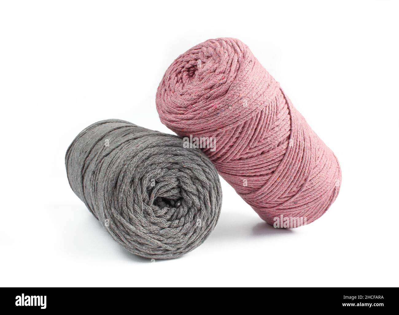 Grey and pink thread rolls for knitting isolated on white background ...