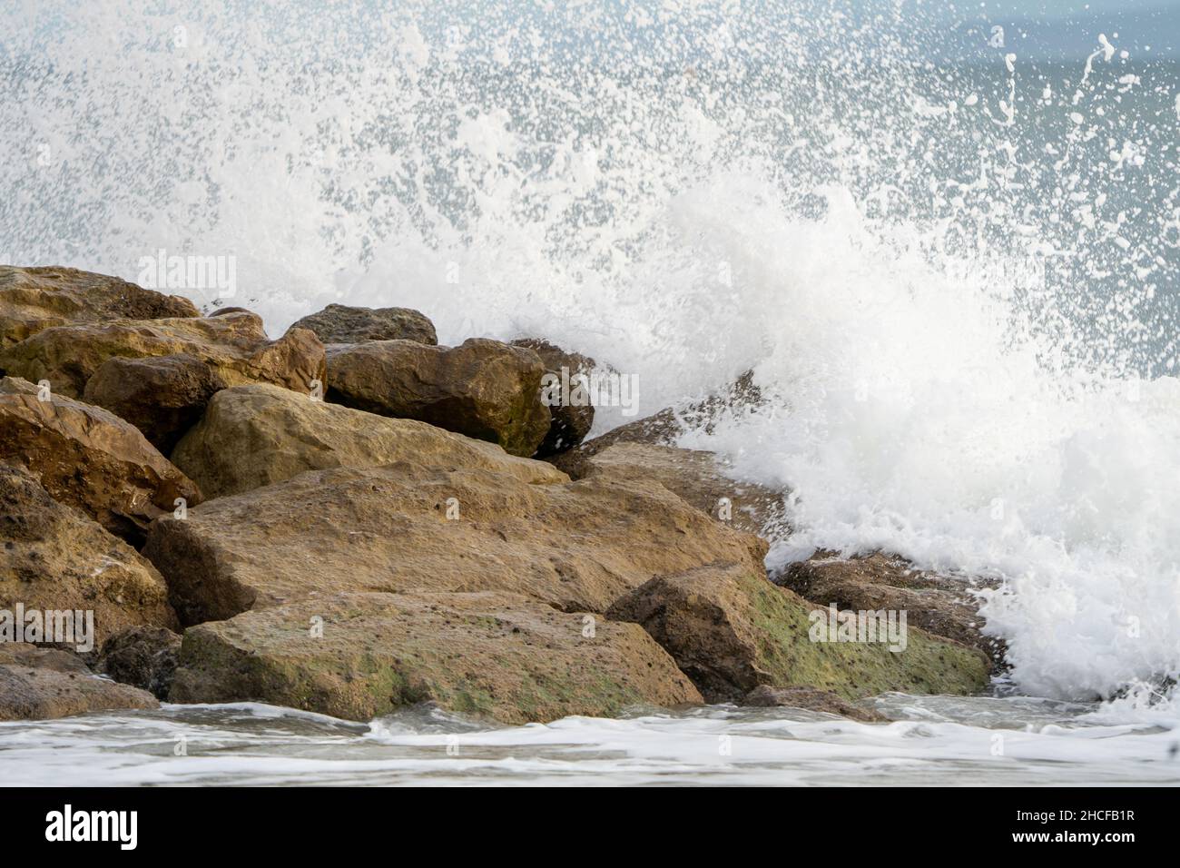 Waves Crashing Over Rock Groins Sandbanks Beach UK Stock Photo - Alamy
