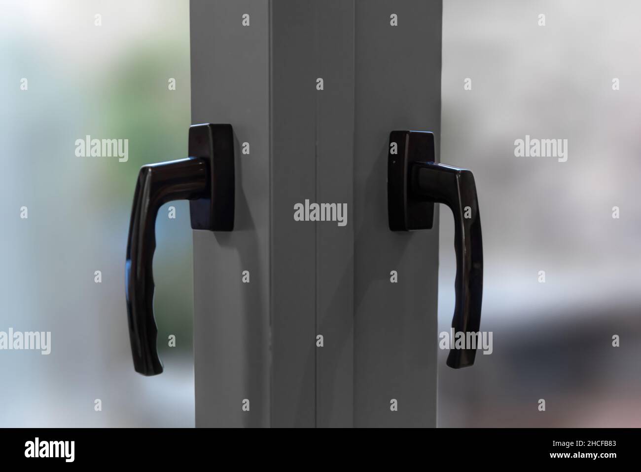 Metal frame window and closed handle closeup view. Two aluminum sliding ...