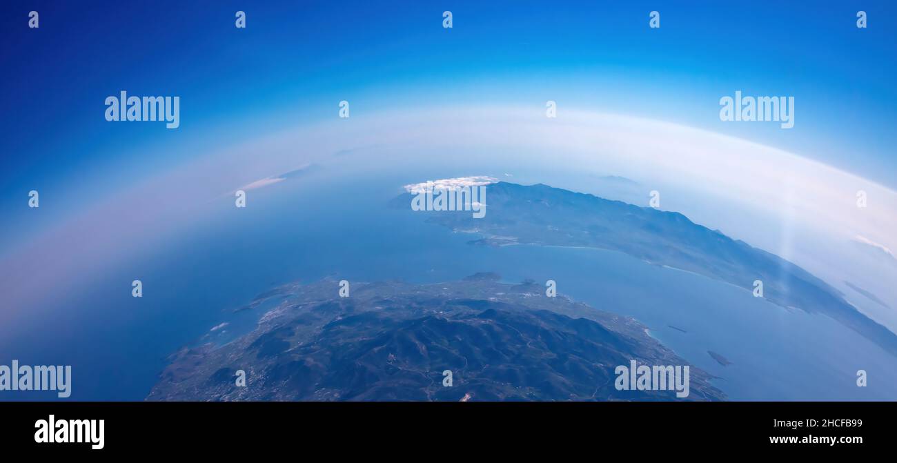 Curvature of planet earth. Aerial shot. Blue sky and clouds over island ...