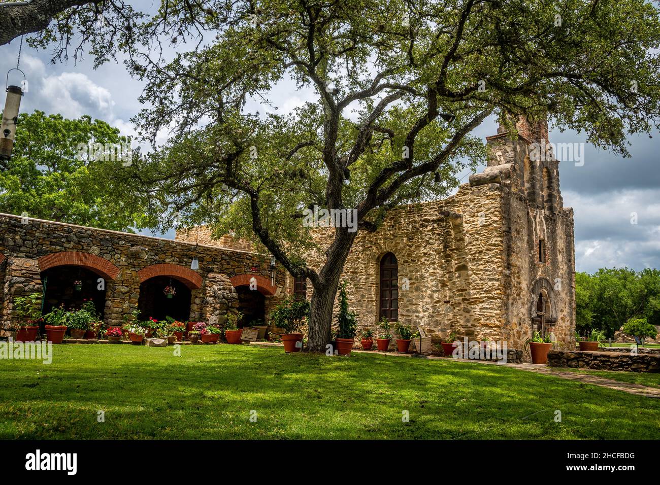 The historic Mission Espada towering over its vibrant surroundings ...