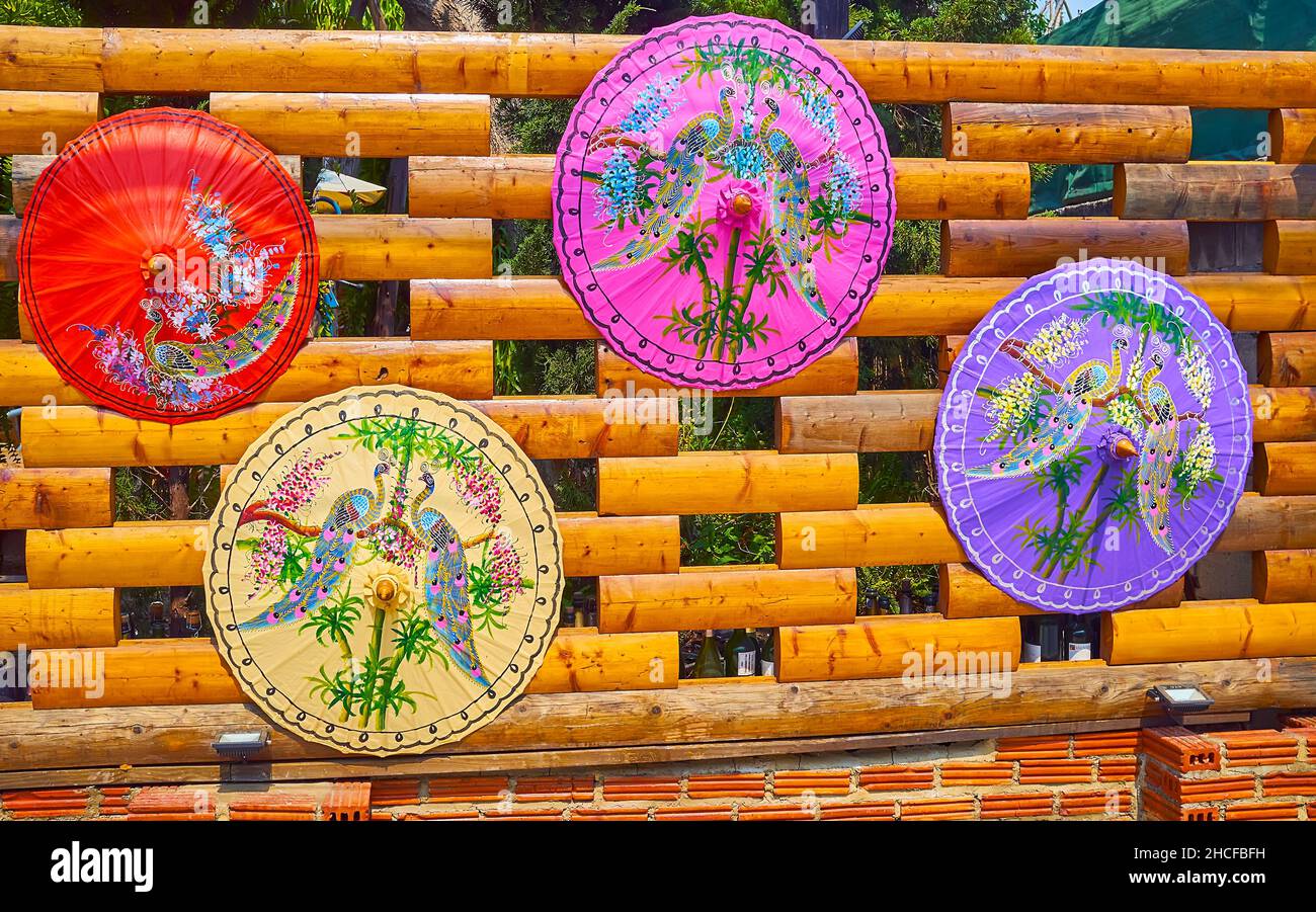 Traditional Thai paper sun parasols with colorful paintings of birds ...