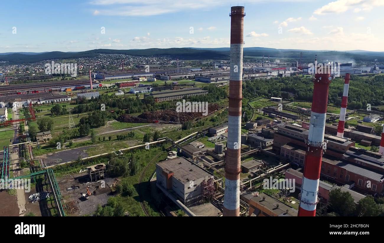 Aerial for factory chimneys and the cityscape in a summer, sunny day ...