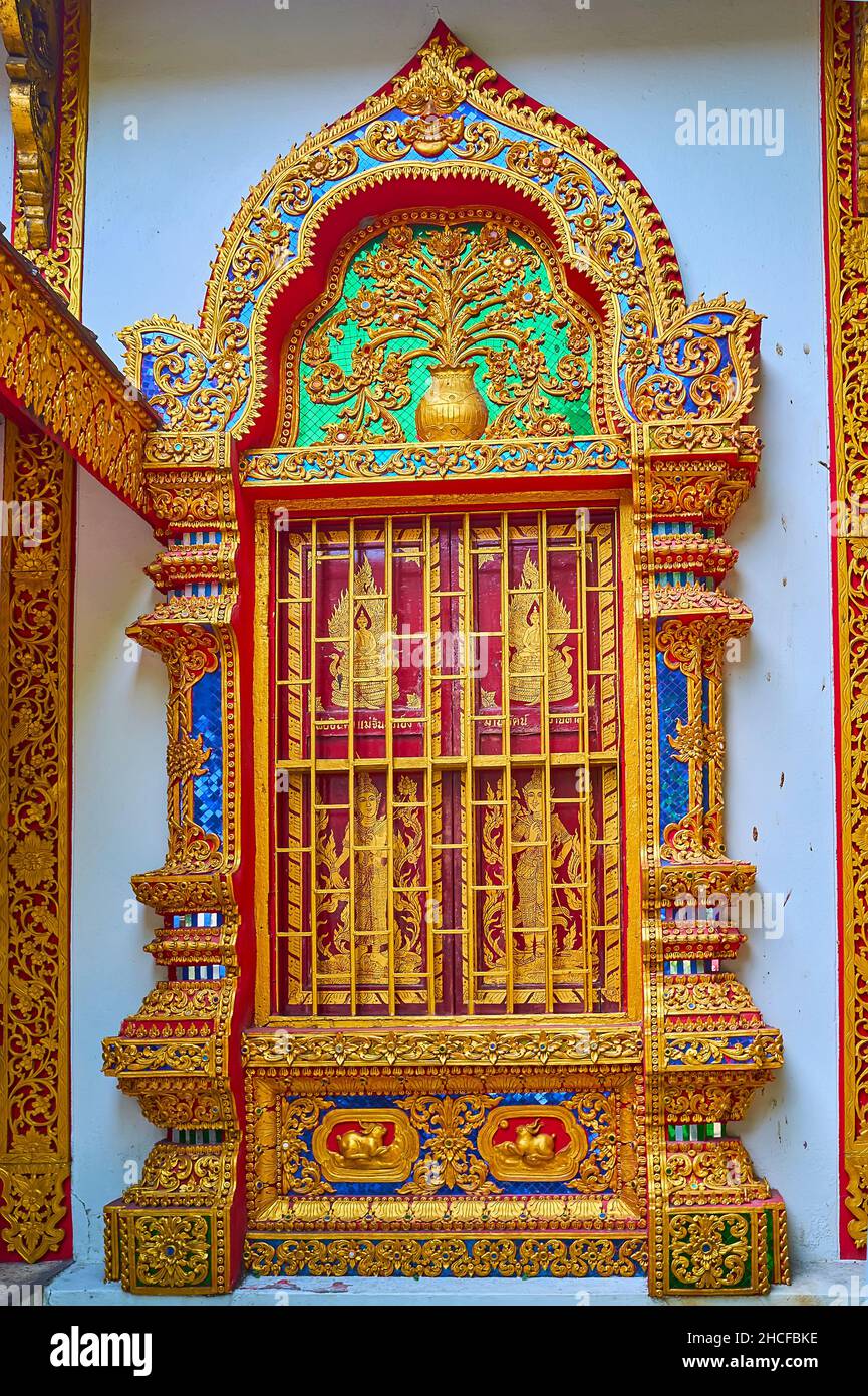 Ornate window and its frame, decorated with gilt grilles, wooden ...