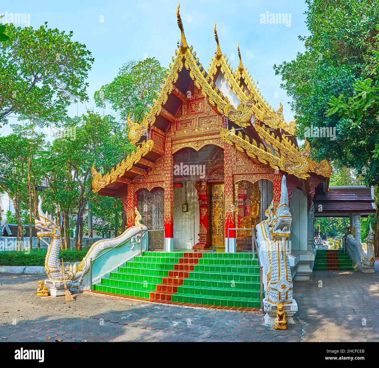 The ornate viharn of Wat Phan Waen temple is decorated with intricate ...