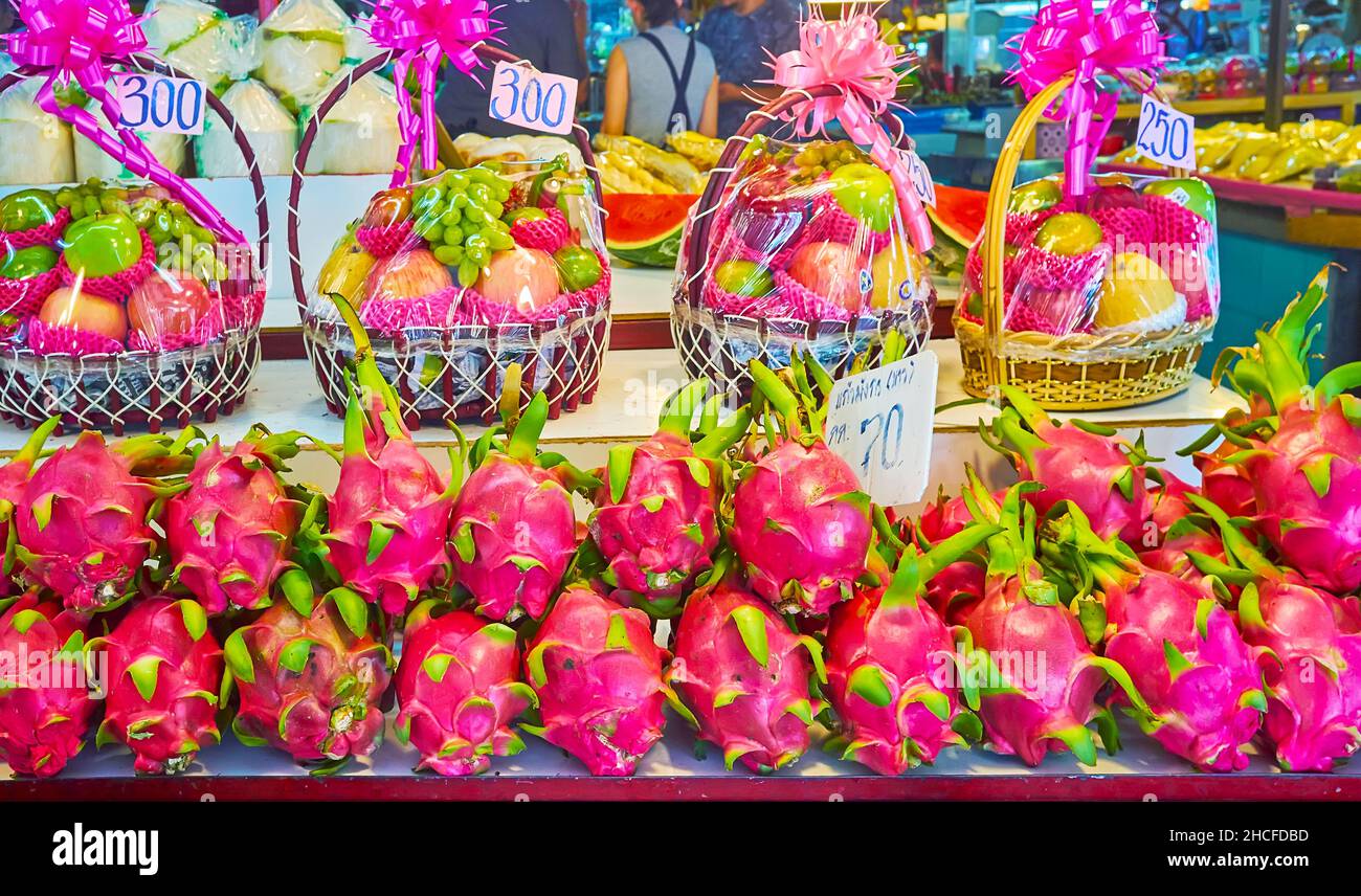 The counter of the fresh fruit stall with heap of bright pink dragon ...