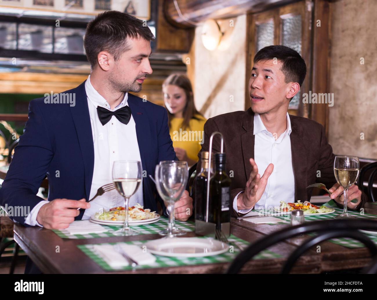 Gentlemen are having dinner in luxury restaurante Stock Photo - Alamy