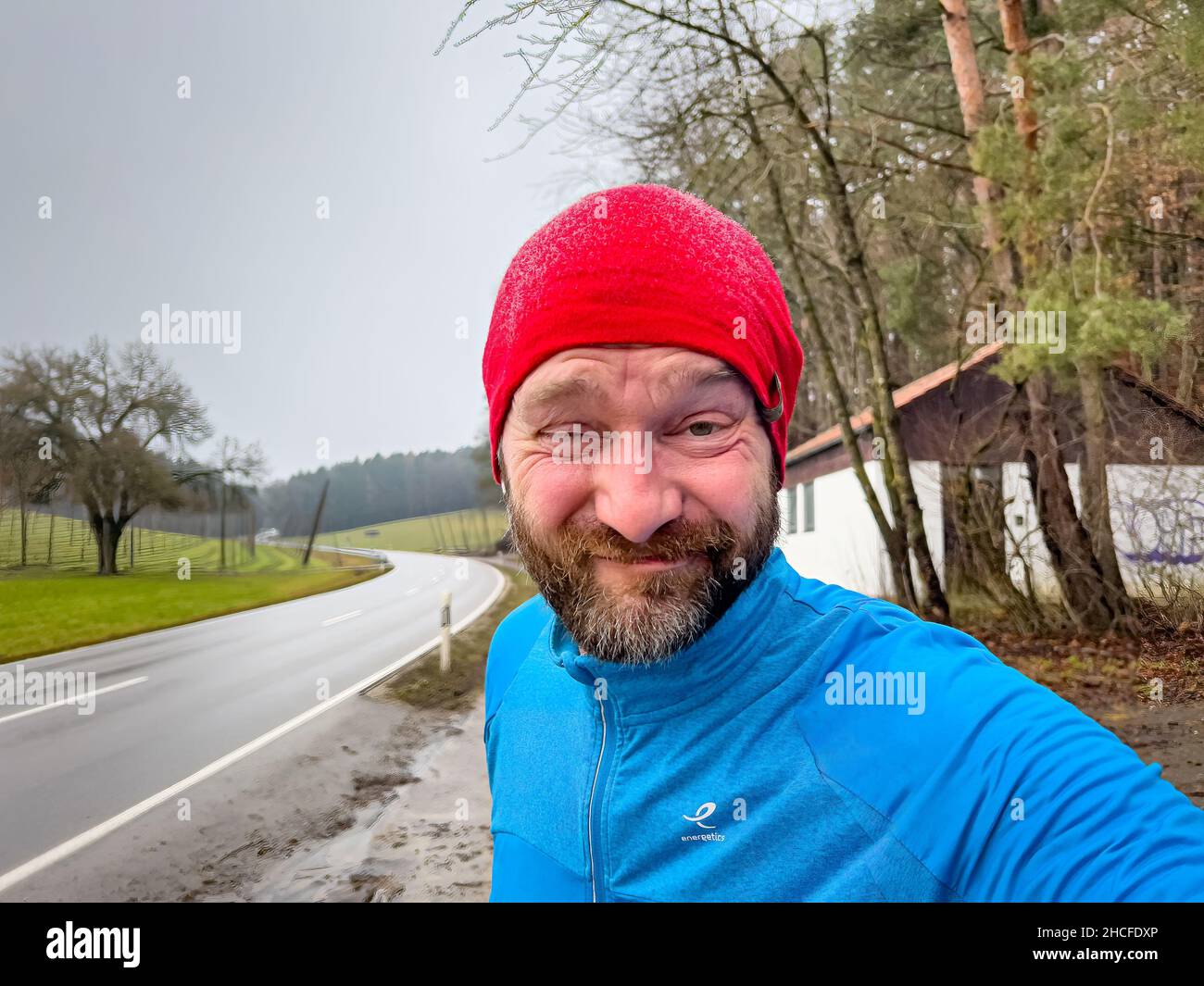 Running Man with Red Cap during Winter Stock Photo - Alamy