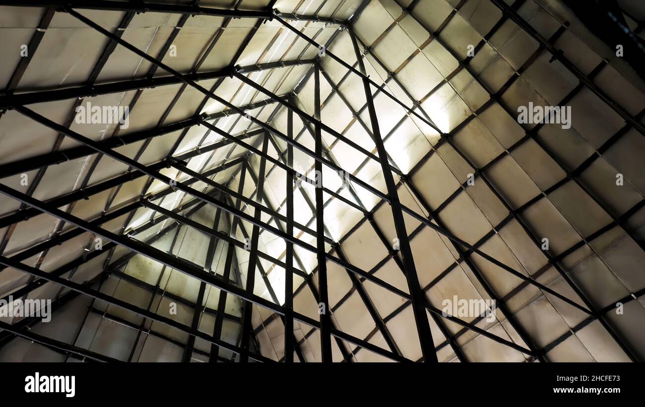 Metal sections of the roof of an industrial warehouse. Bottom view of ...