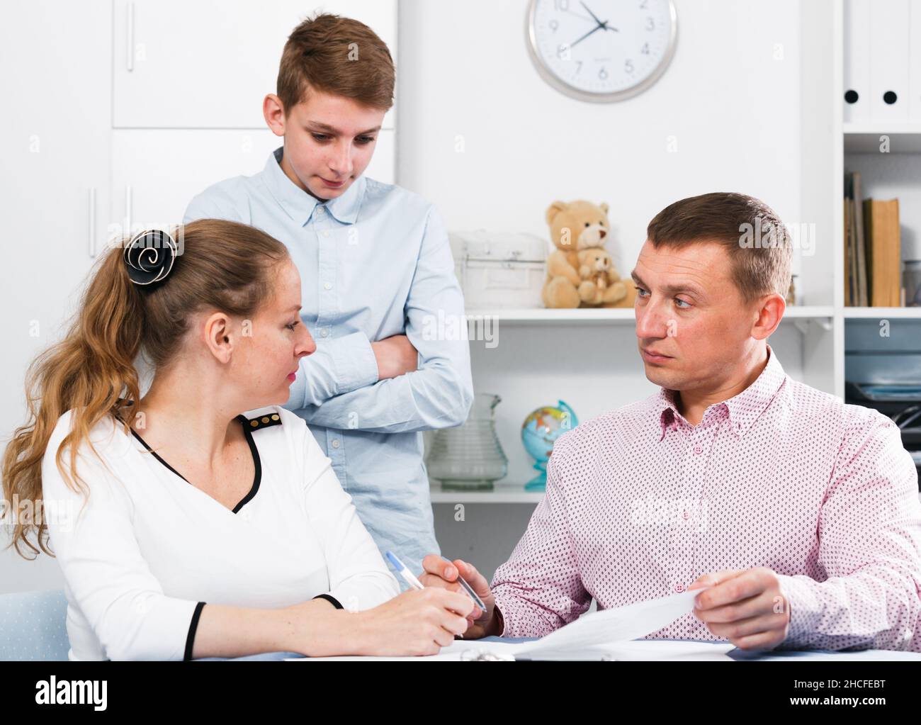 Mother and son signing documents Stock Photo - Alamy
