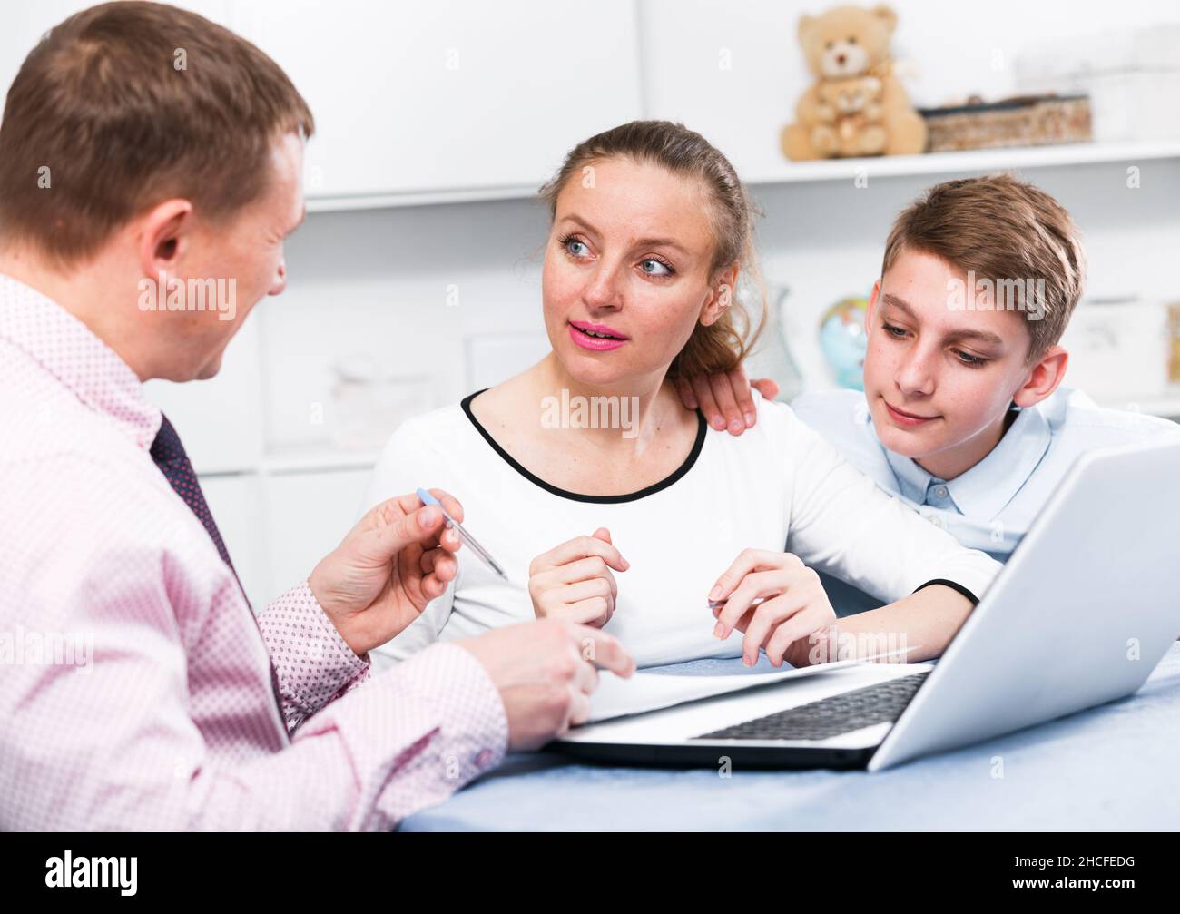 Mother and son signing documents Stock Photo - Alamy
