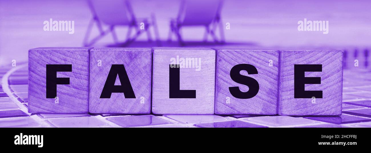 FALSE word made with building cube blocks near the ocean. false or true ...