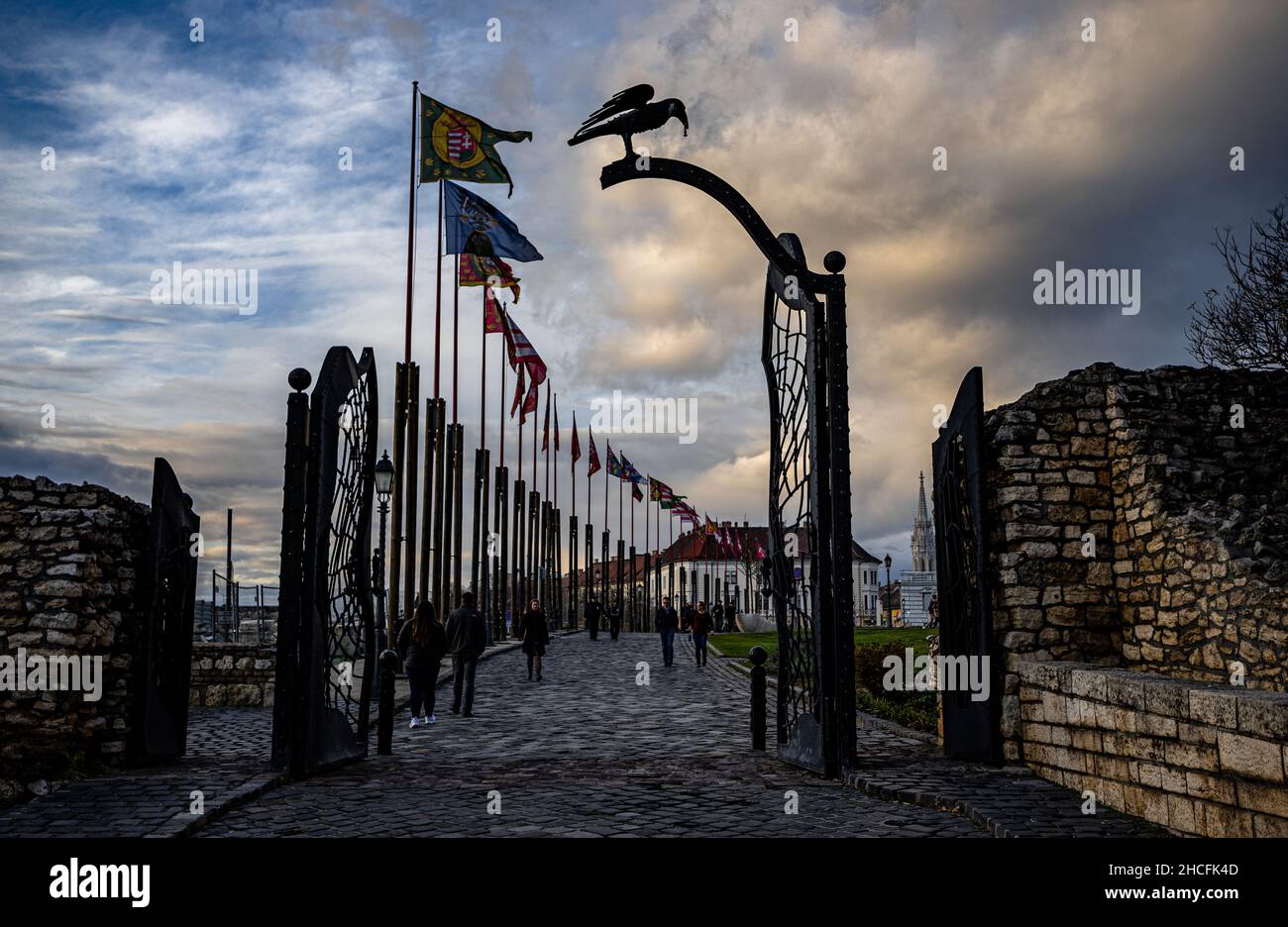 Metal gate and a row of flags on a gloomy trail in Budapest Stock Photo ...