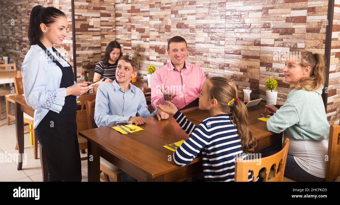 Waitress taking order from guests Stock Photo - Alamy