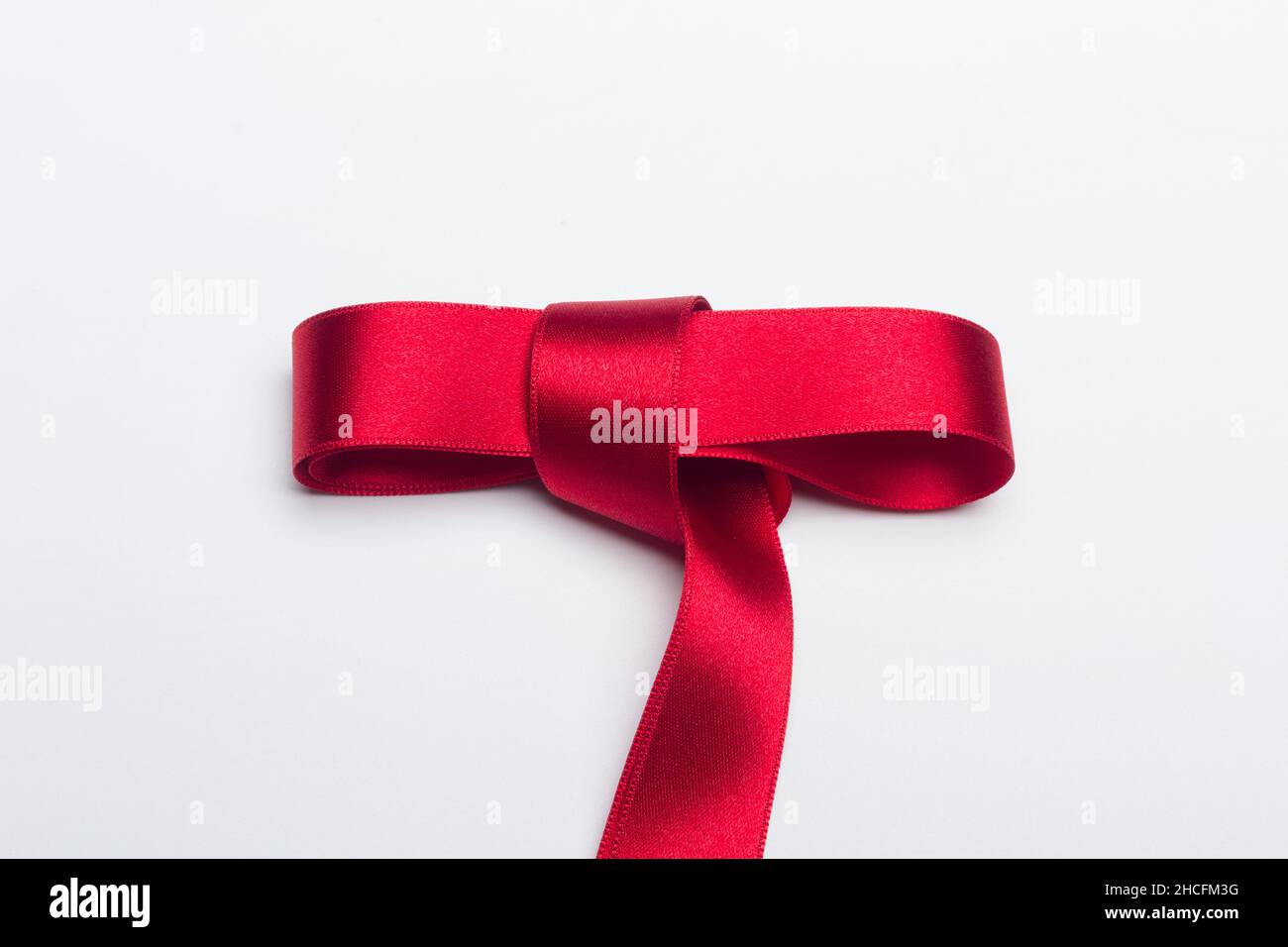 Red ribbon for gift wrapping on a white background Stock Photo - Alamy