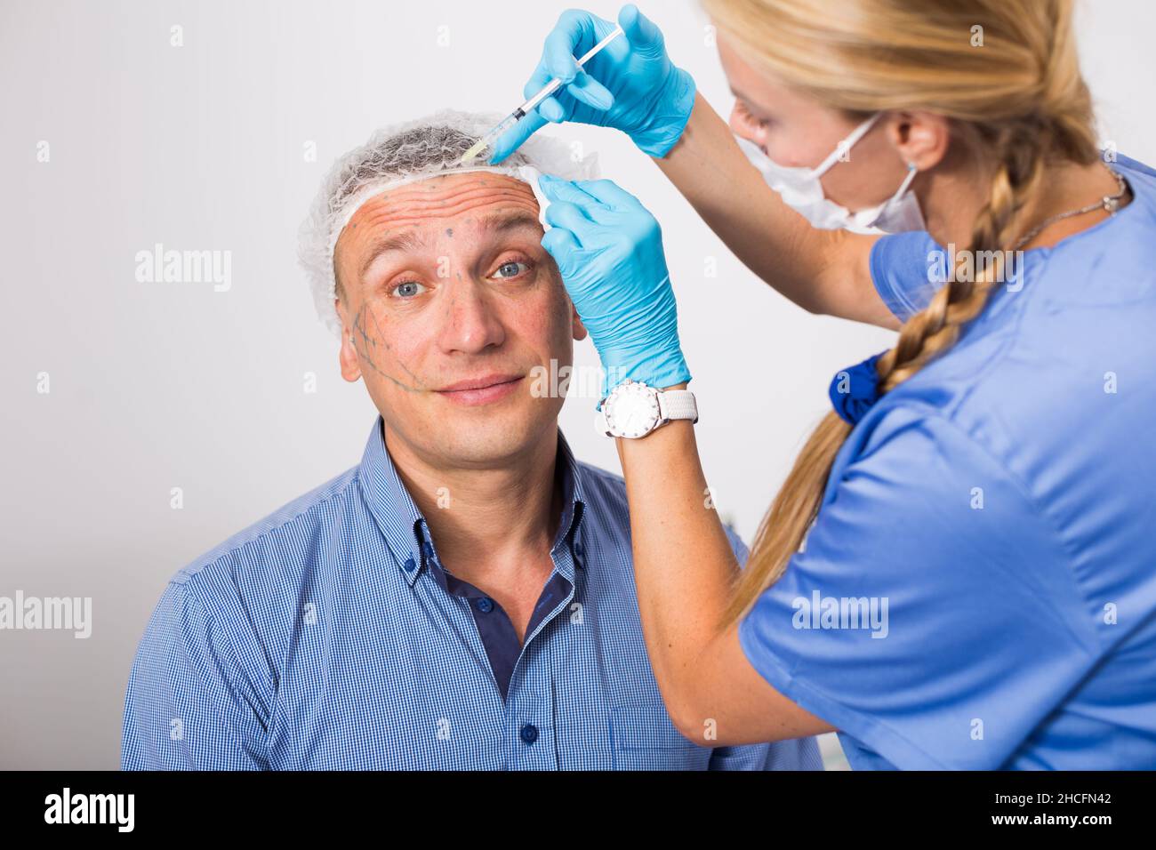 Female doctor is doing injection to patient in skin of face Stock Photo ...
