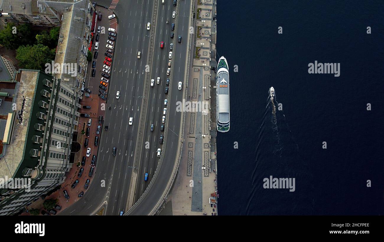 A beautiful aerial view of cars on a highway next to a yacht in the ...