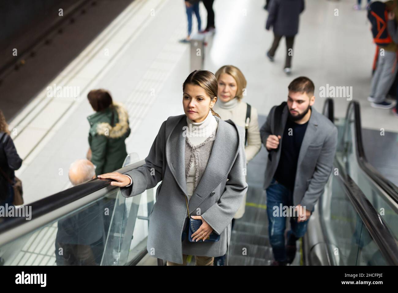 People moving up on escalator Stock Photo - Alamy